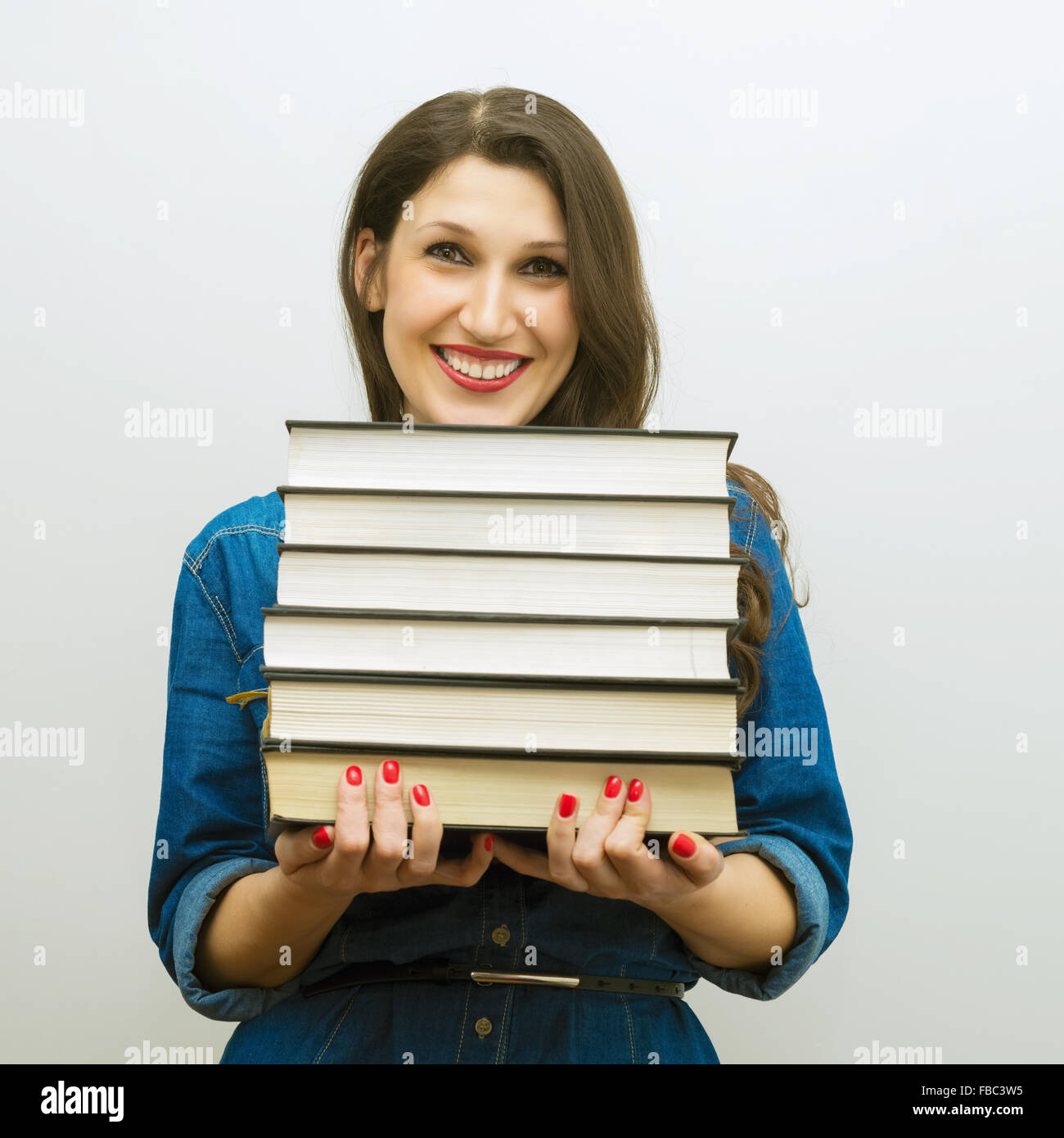 Attractive cheerful woman with books Stock Photo - Alamy