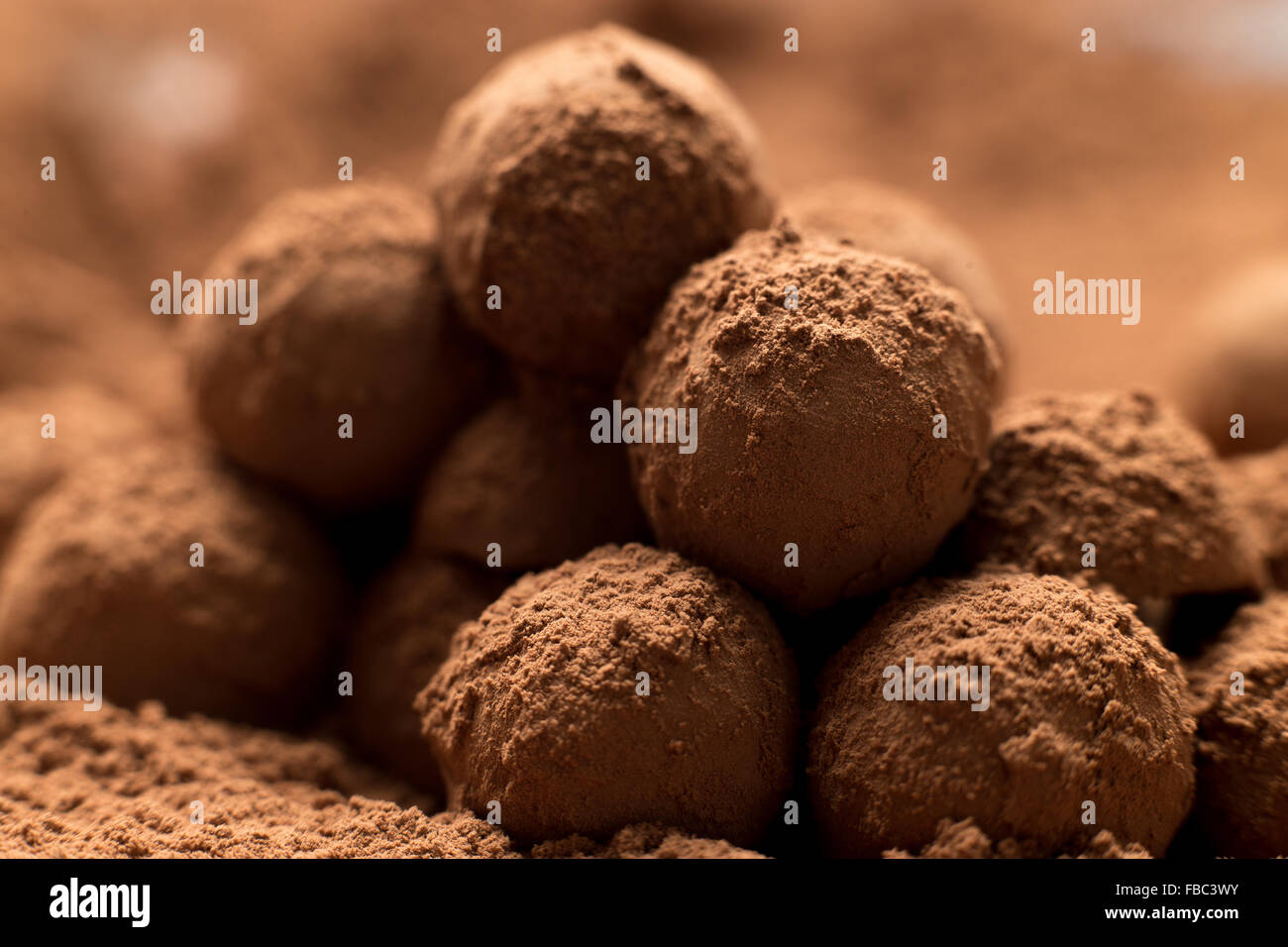 Homemade confectionery. Stack of enticing dark chocolate balls covered ...
