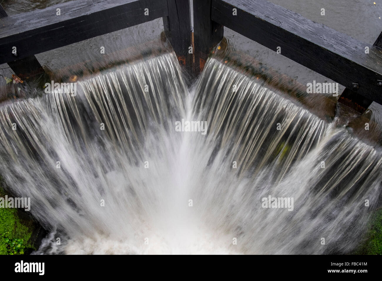 Lock gates with water flowing over the tops Stock Photo - Alamy
