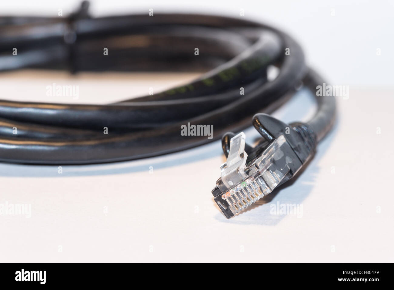 The black internet cable on white background Stock Photo - Alamy