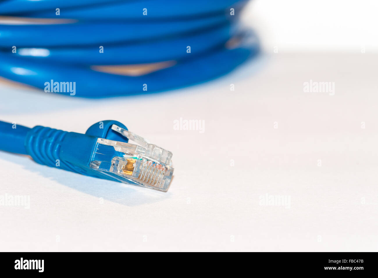 The blue internet cable on white background Stock Photo - Alamy