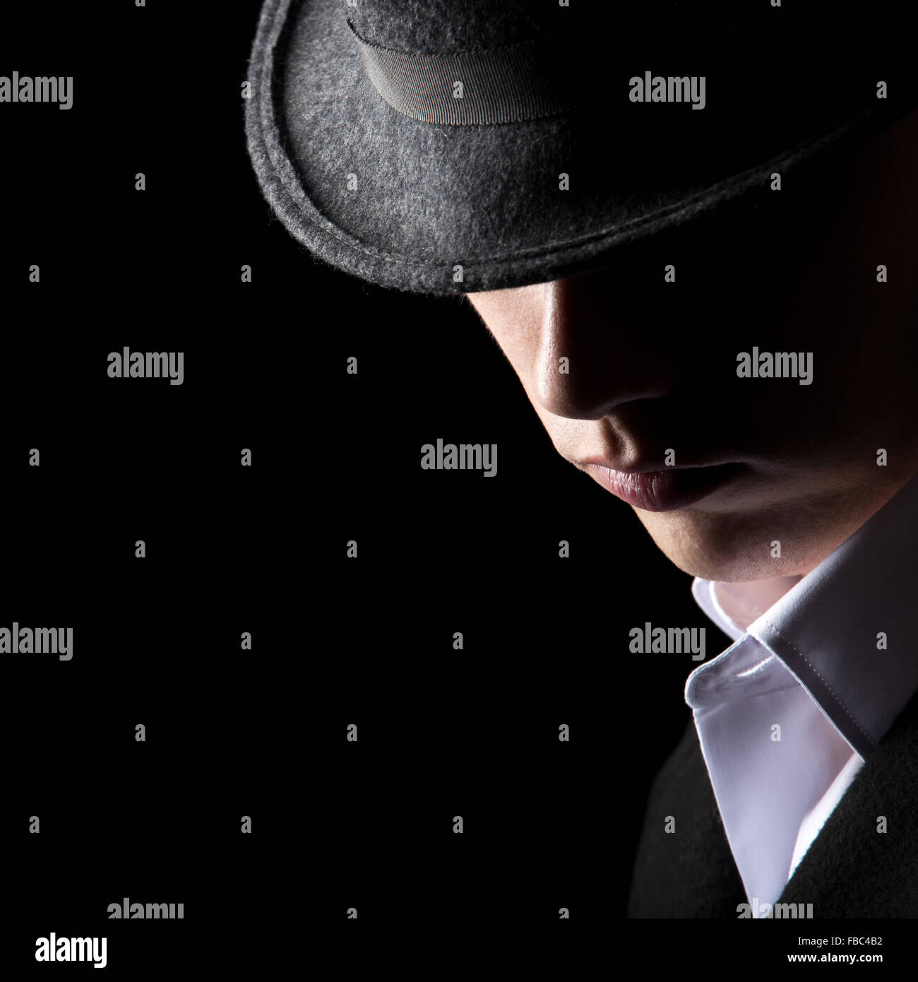 Handsome unrecognizable man in hat, his face in the shadows ...
