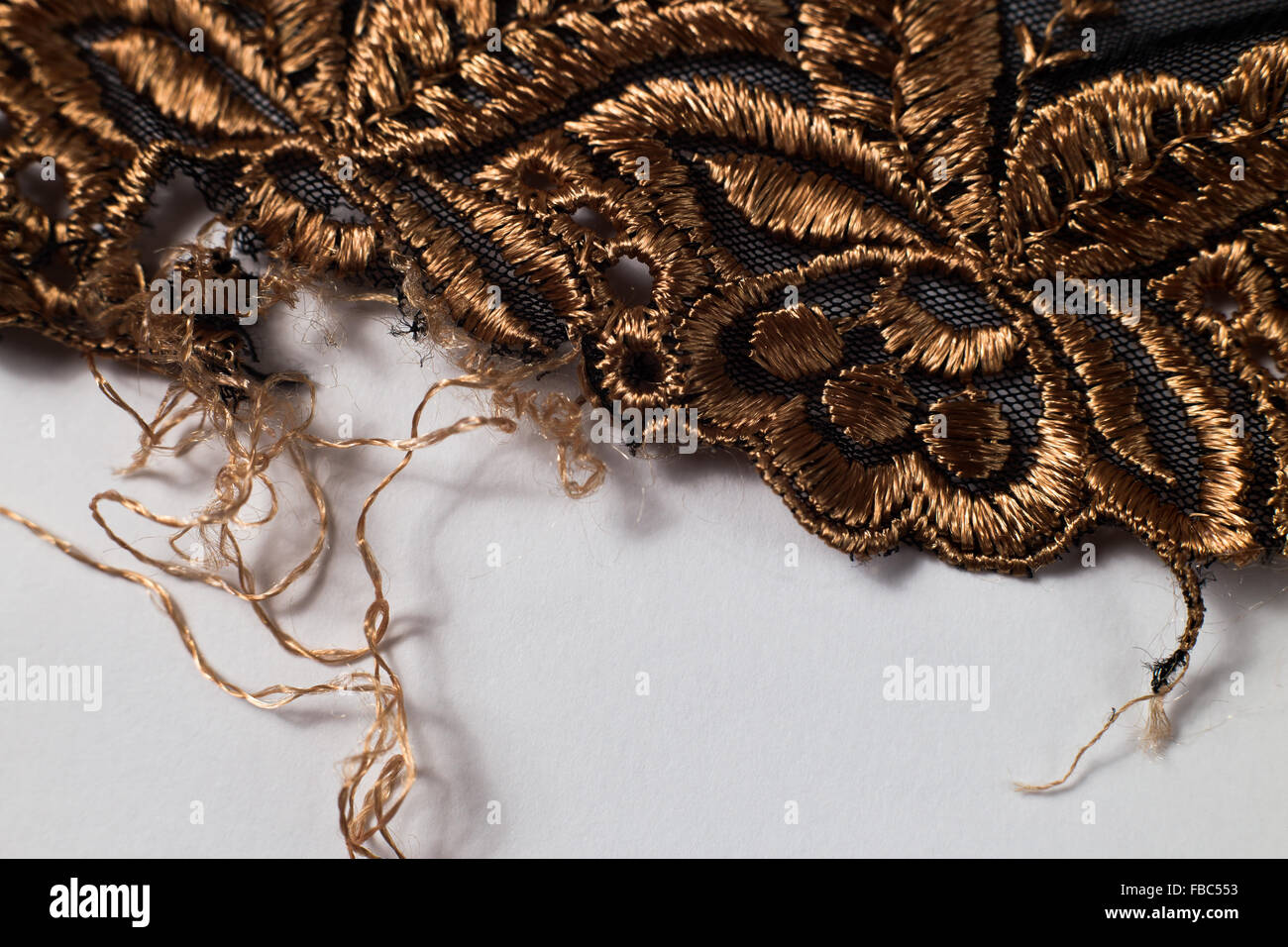Torn black and golden lace fabric Stock Photo - Alamy