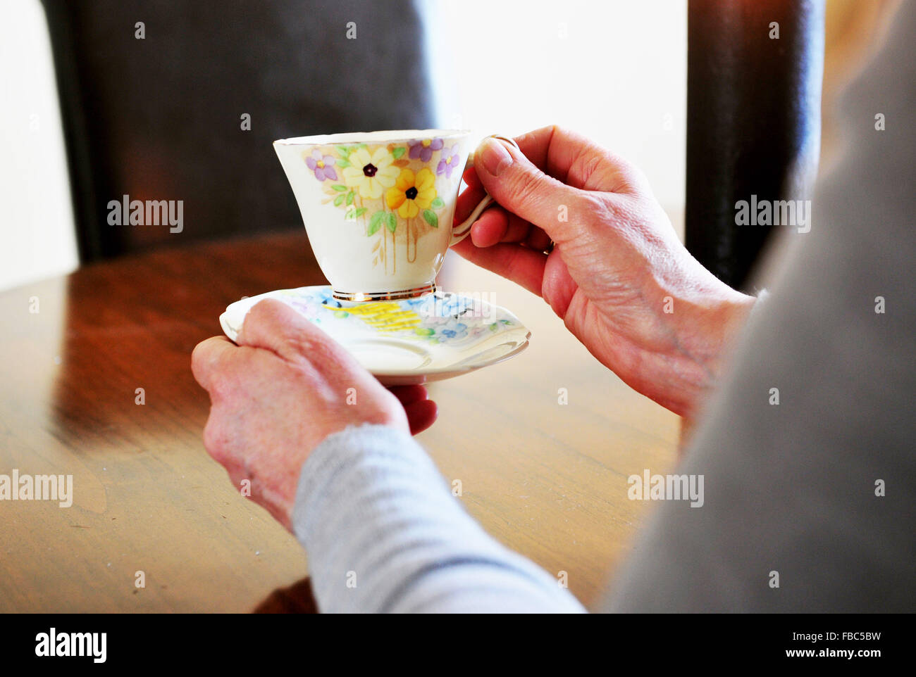 Old lady holding tea cup hi-res stock photography and images - Alamy