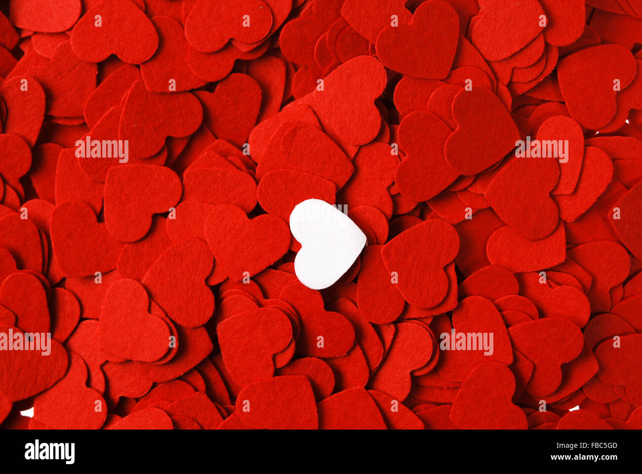 small white heart on the background of the little red hearts Stock ...