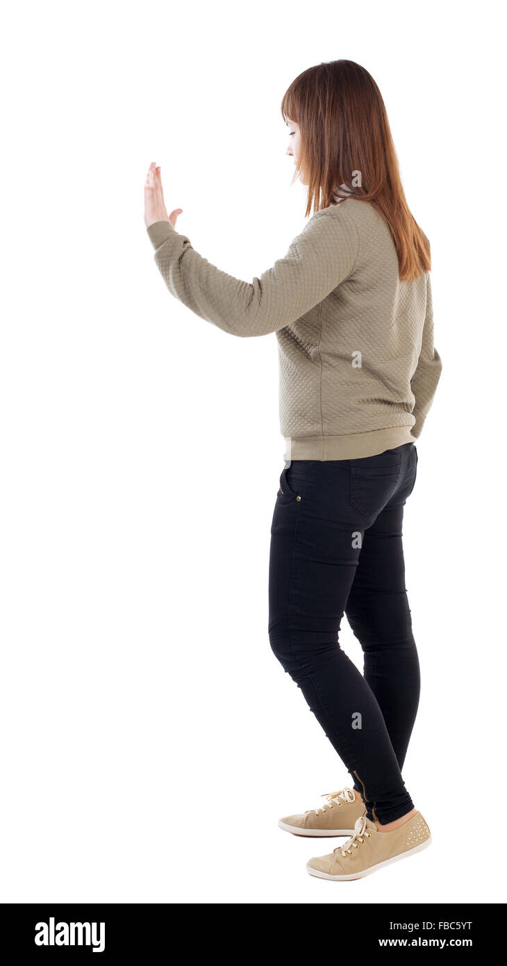 back view of woman. Young woman presses down on something. Isolated ...