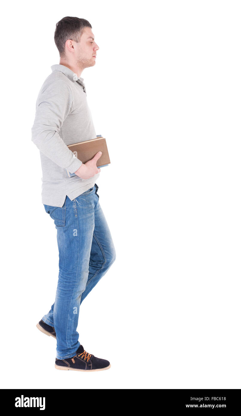 man goes and has a stack of books. back view. Rear view people ...