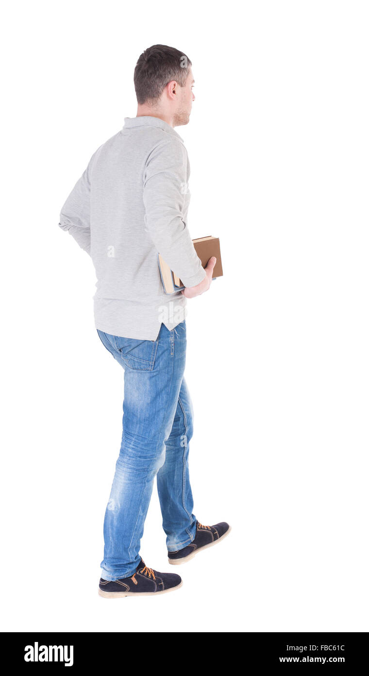 man goes and has a stack of books. back view. Rear view people ...