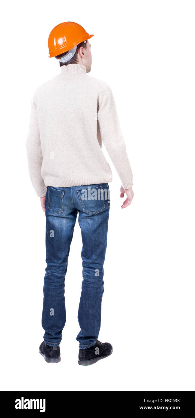 Backview of an engineer in construction helmet stands. Standing young ...