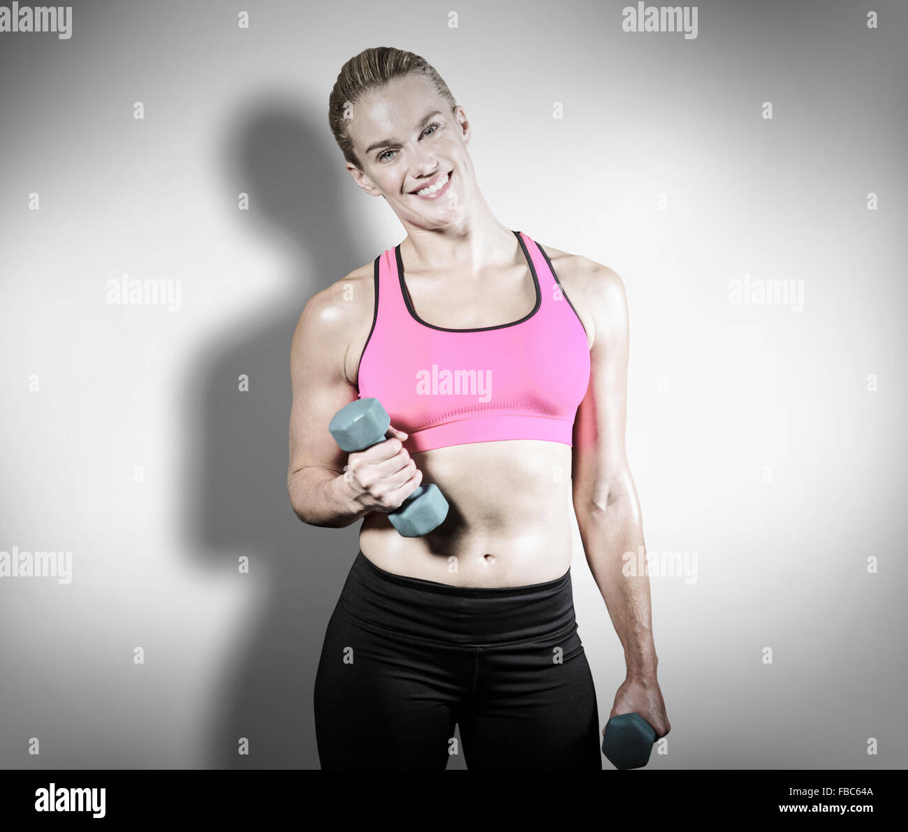 Composite image of muscular woman lifting heavy dumbbells Stock Photo ...
