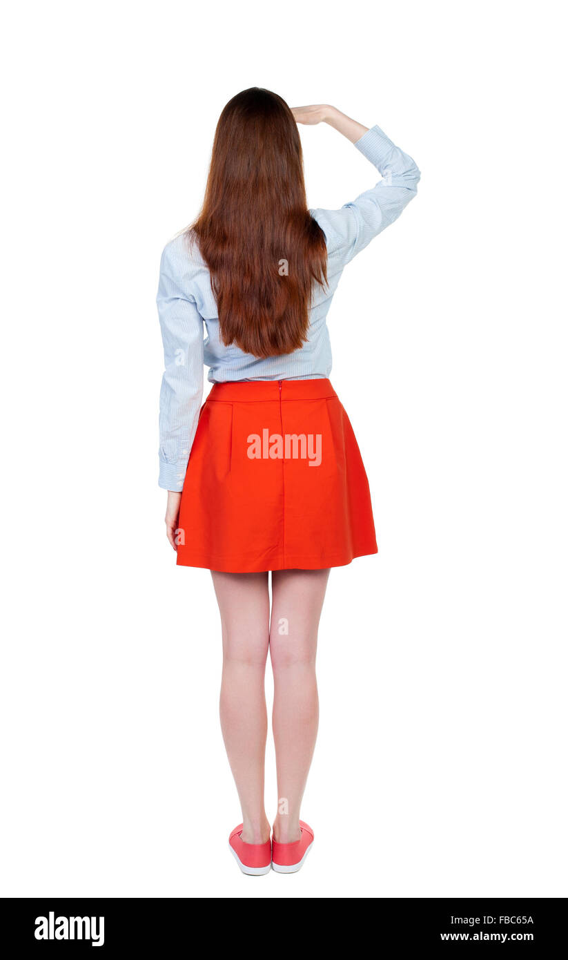 back view of standing young beautiful woman. girl watching. Rear view ...