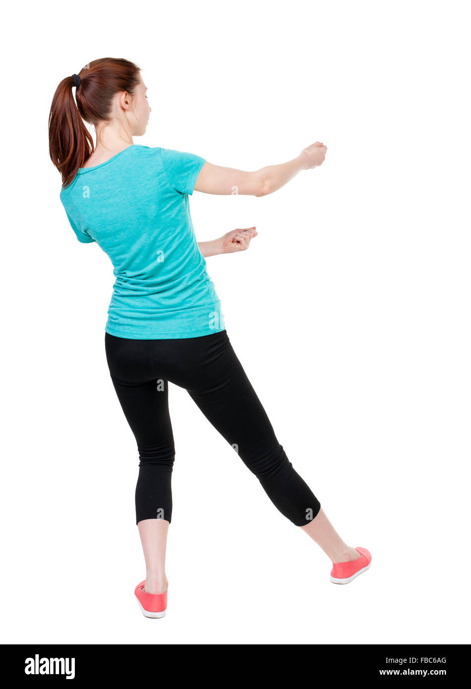 back view of standing woman pulling a rope from the top or cling to ...