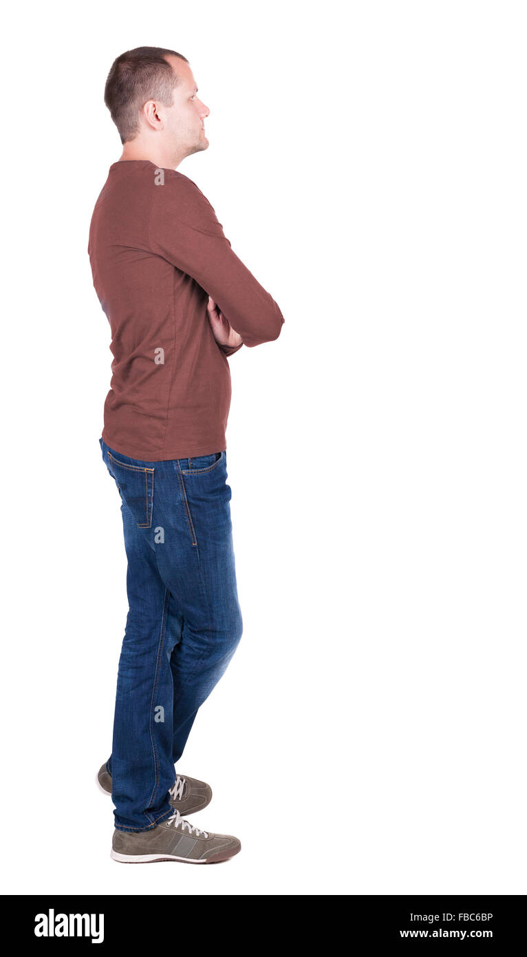 Back view of young man in t-shirt and jeans looking. Standing young guy ...