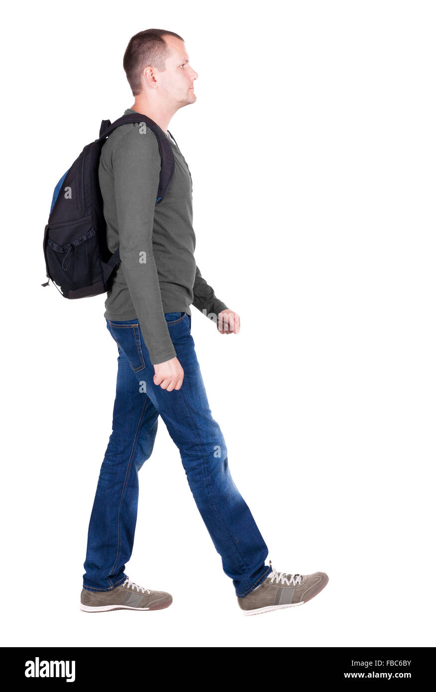 back view of walking man with backpack. brunette guy in motion ...
