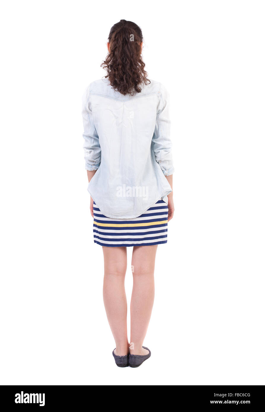 back view of standing young beautiful woman. girl watching. Rear view ...