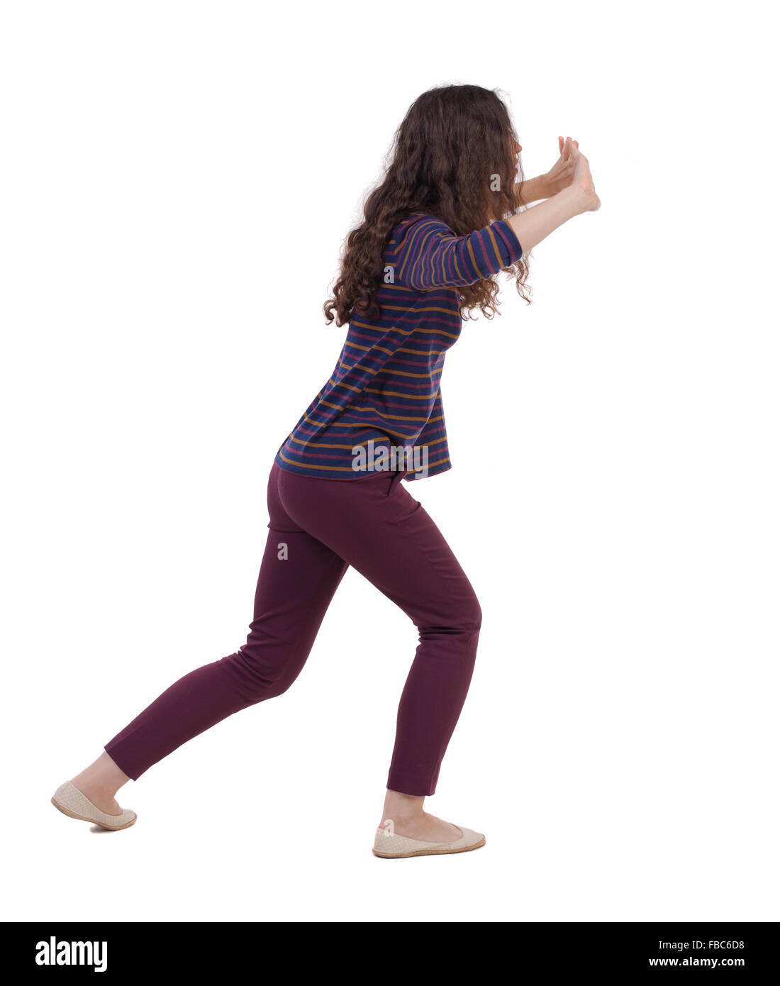 back view of woman pushes wall. Isolated over white background. Rear ...