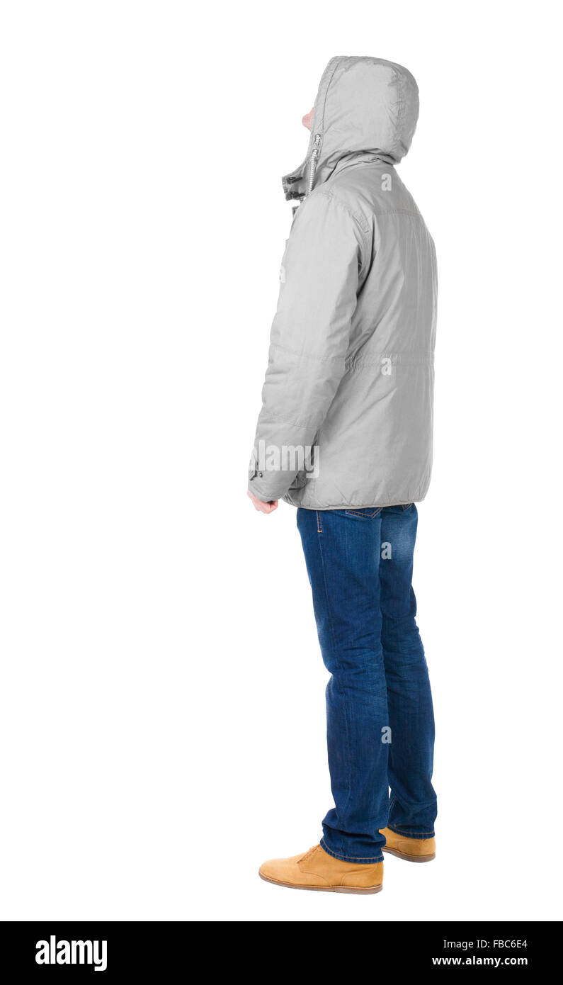 Back view of handsome man in winter jacket looking up. Standing young ...