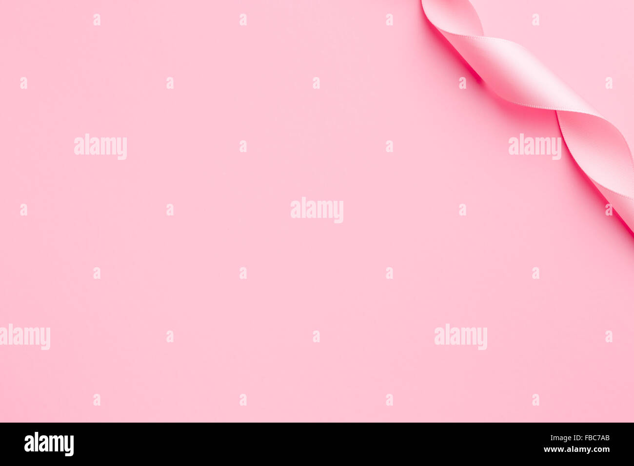 the pink ribbon curls on a pink background Stock Photo - Alamy