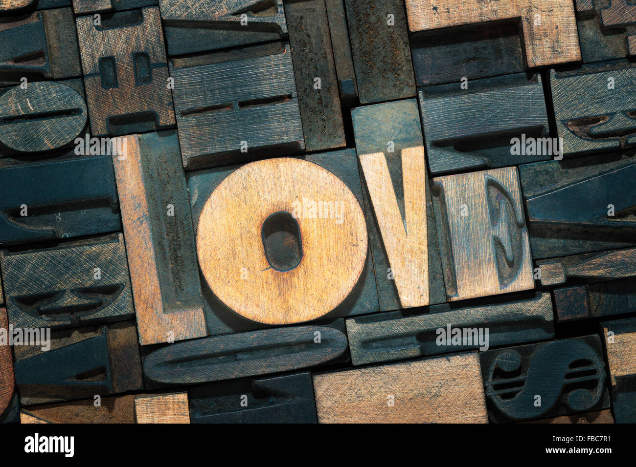 love word made from wooden letterpress blocks inside many letters ...