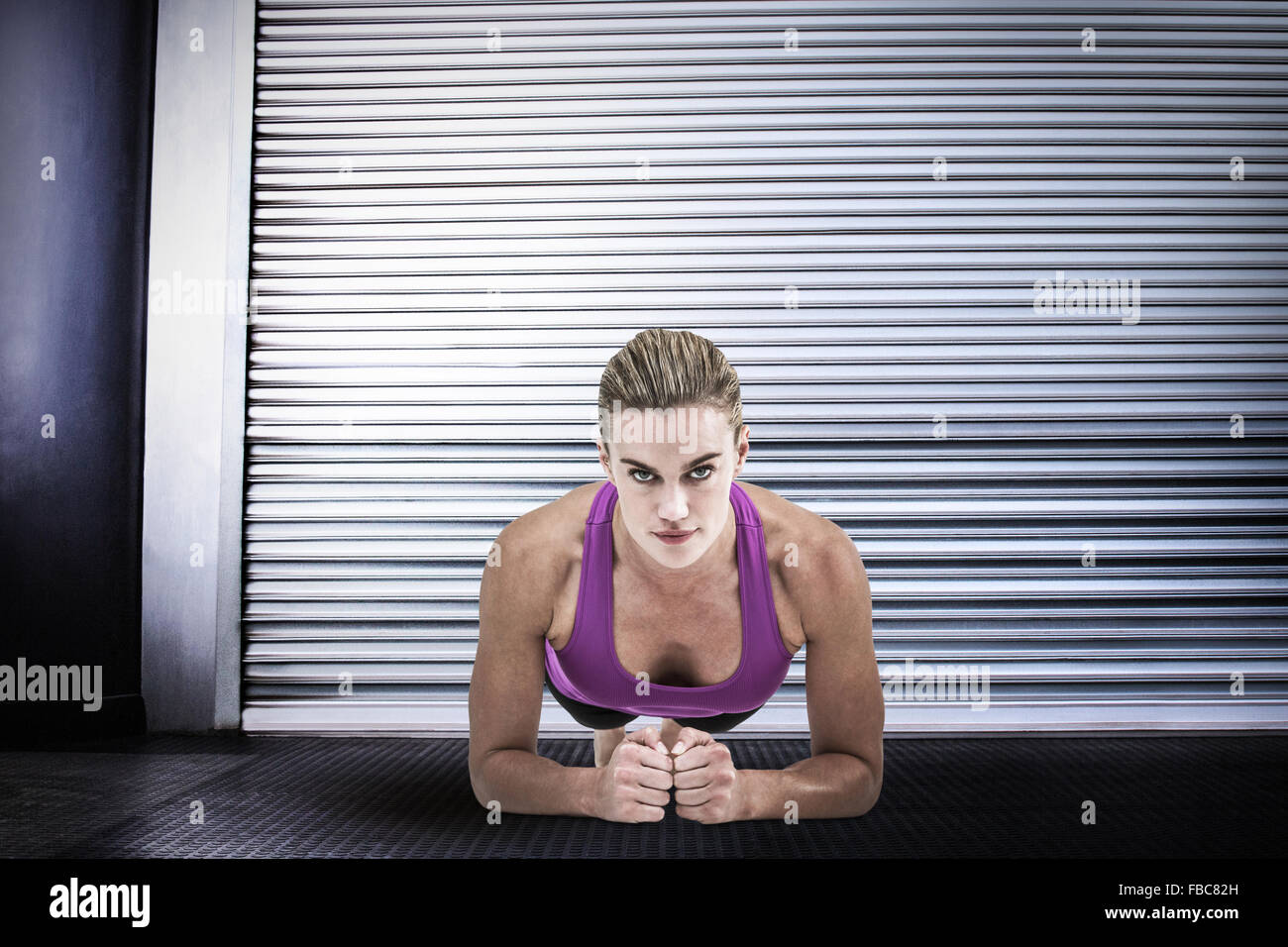 Composite image of muscular woman doing push ups Stock Photo - Alamy