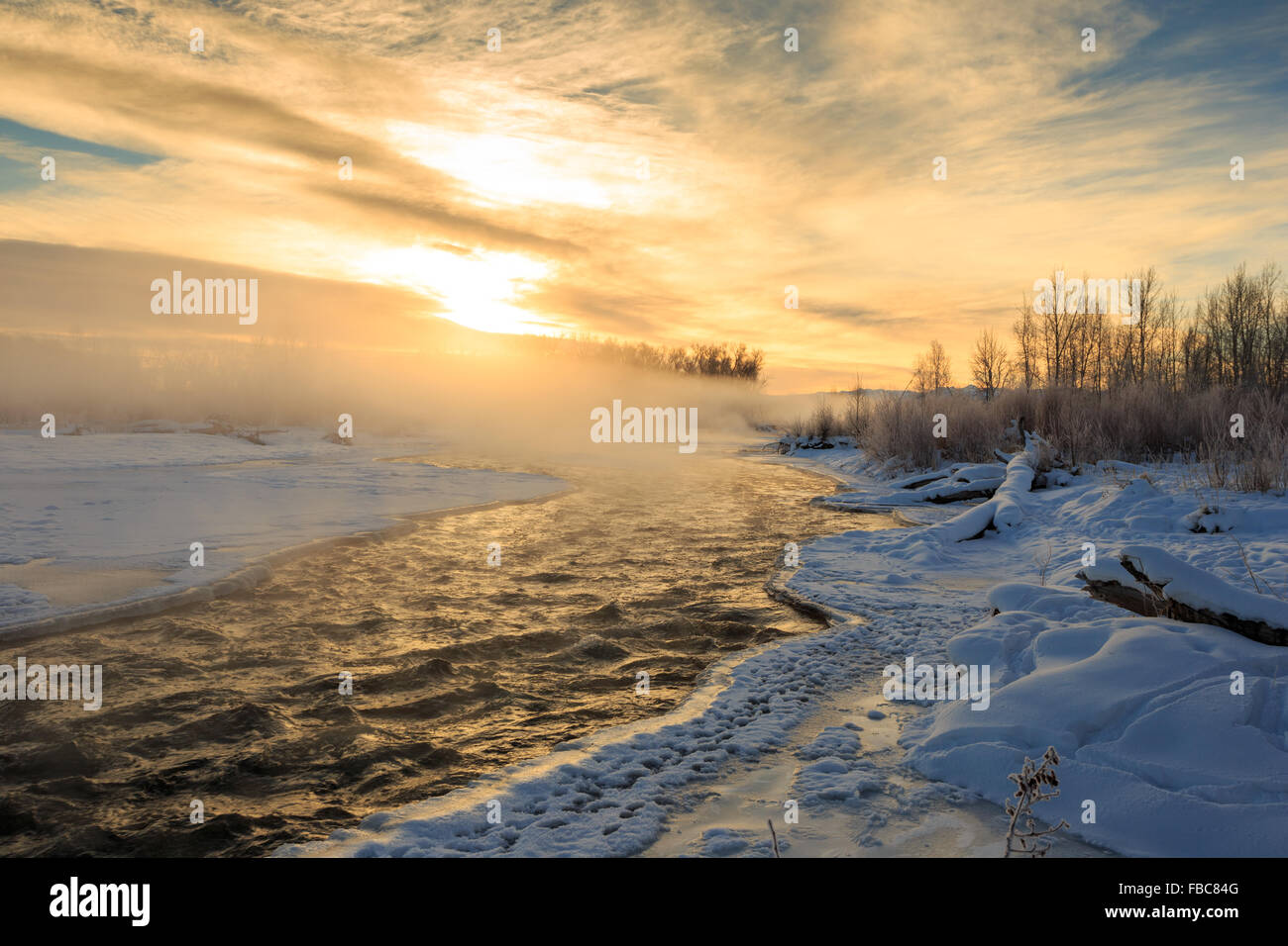 Snowy winter morning sunrise over river and forest landscape Stock ...