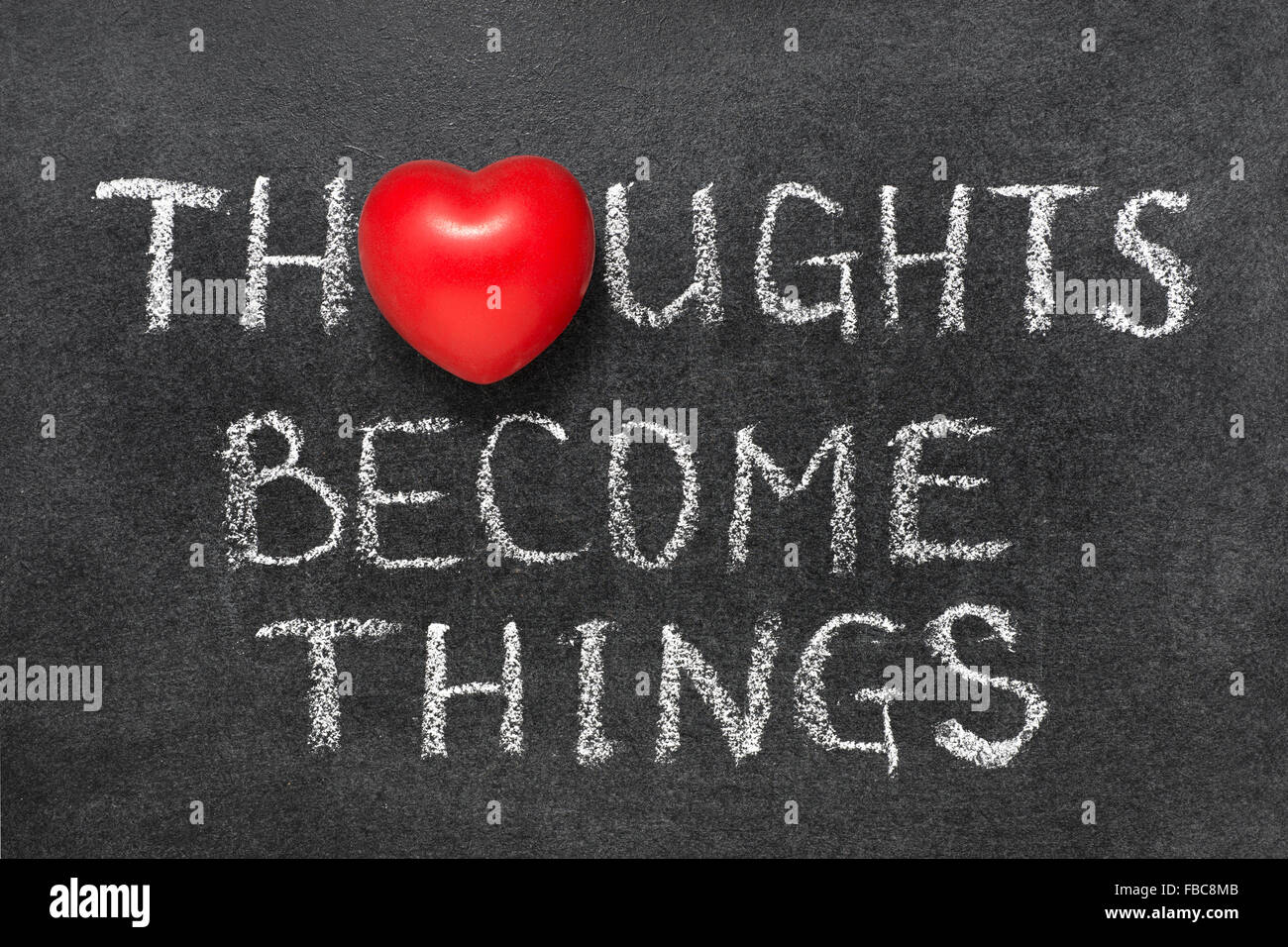 thoughts become things phrase handwritten on blackboard with heart ...