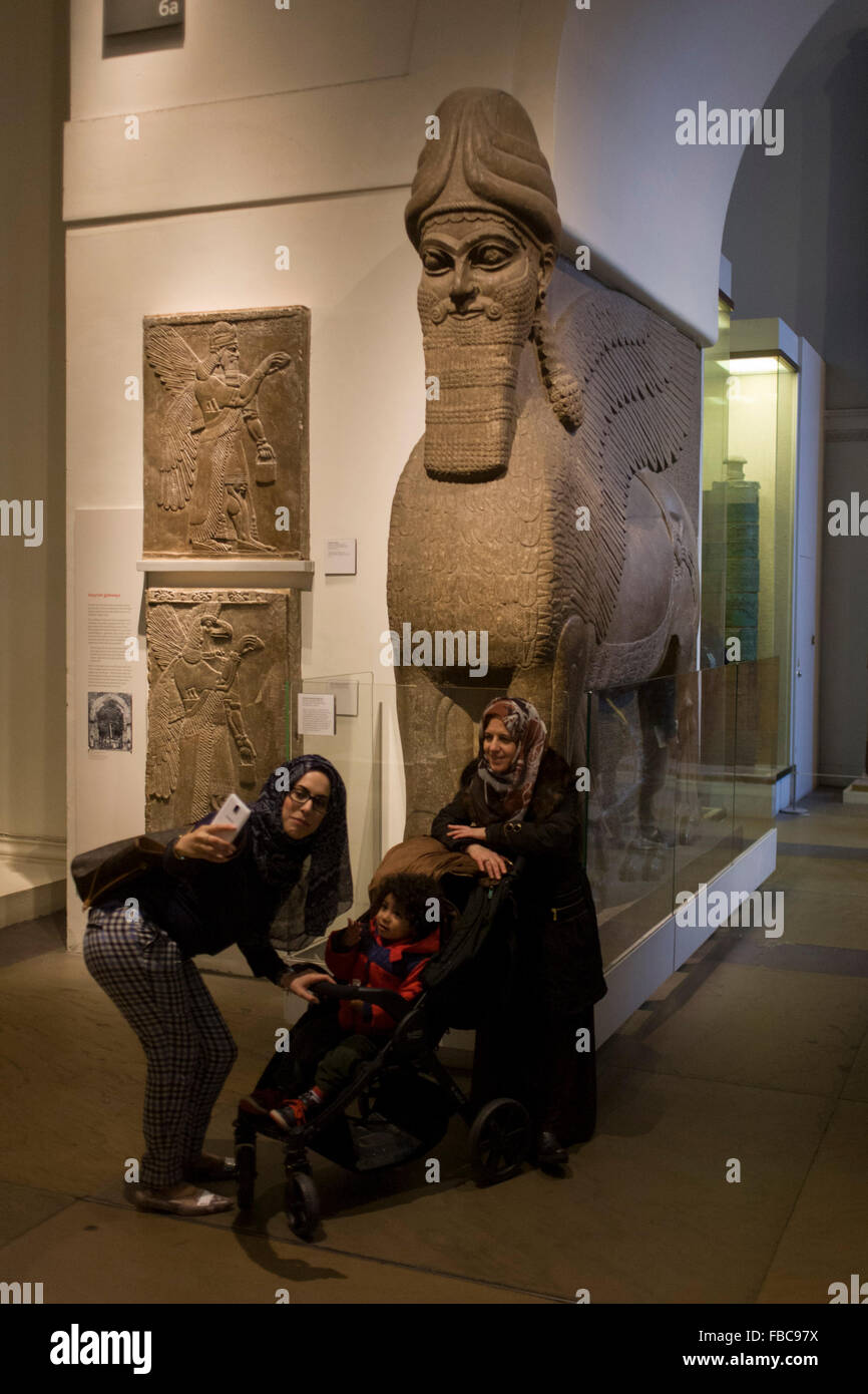 Muslim visitors pose for a selfie beneath the giant Assyrian Winged ...