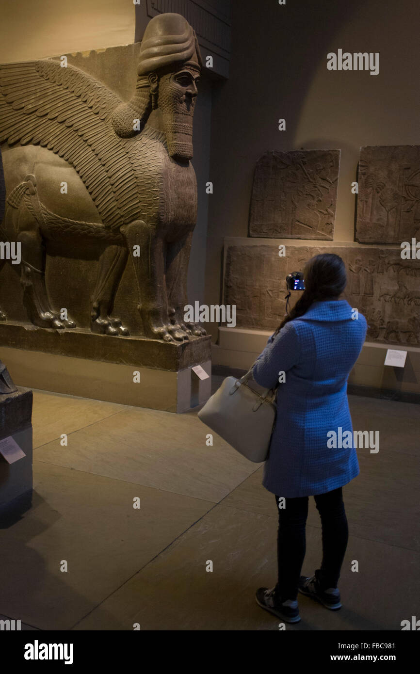 Muslim visitor takes a photo with a smartphone of a pair of giant ...