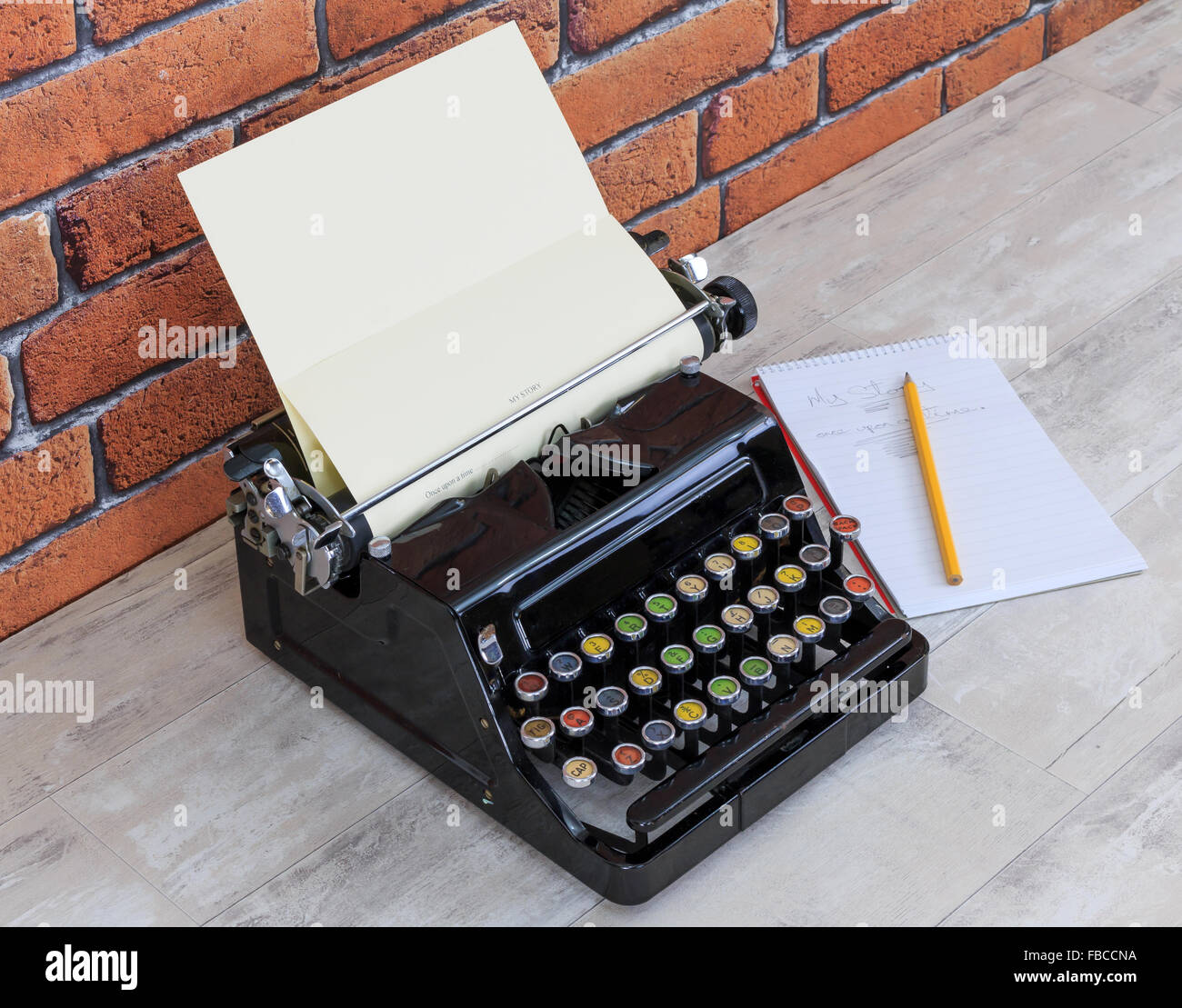 Vintage typewriter, notepad and pencil on old shabby wood effect desk ...