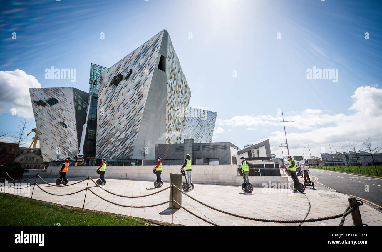 Segway users pass Belfast's iconic Titanic building Stock Photo - Alamy