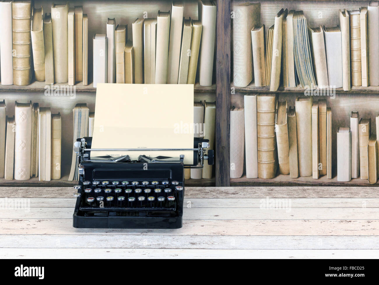 Vintage typewriter on old shabby wood effect desktop with old bookcase ...