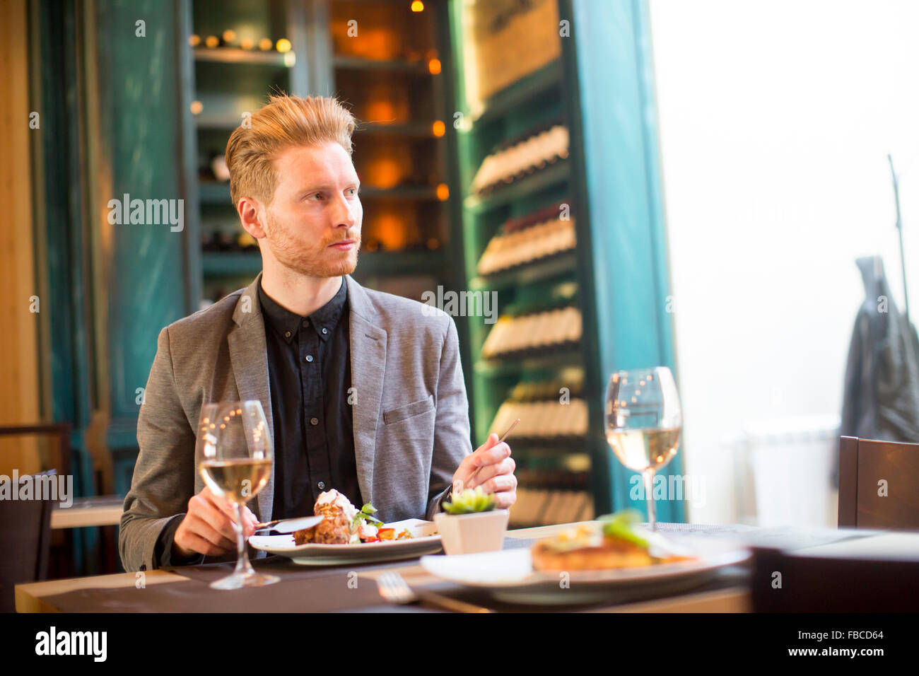Young man at the restaurant Stock Photo - Alamy