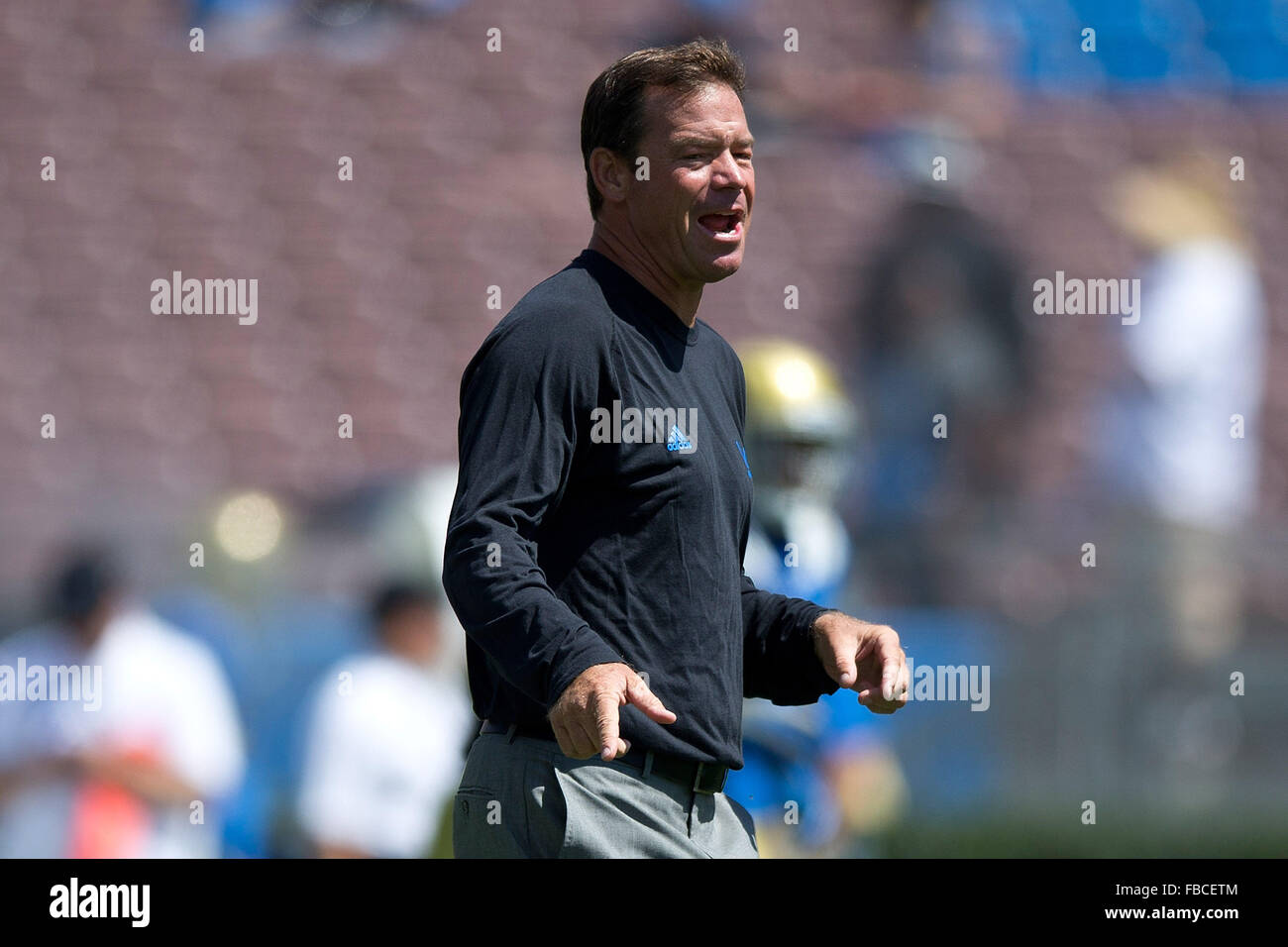 Head coach Jim Mora of the UCLA Bruins stands on the field before the ...