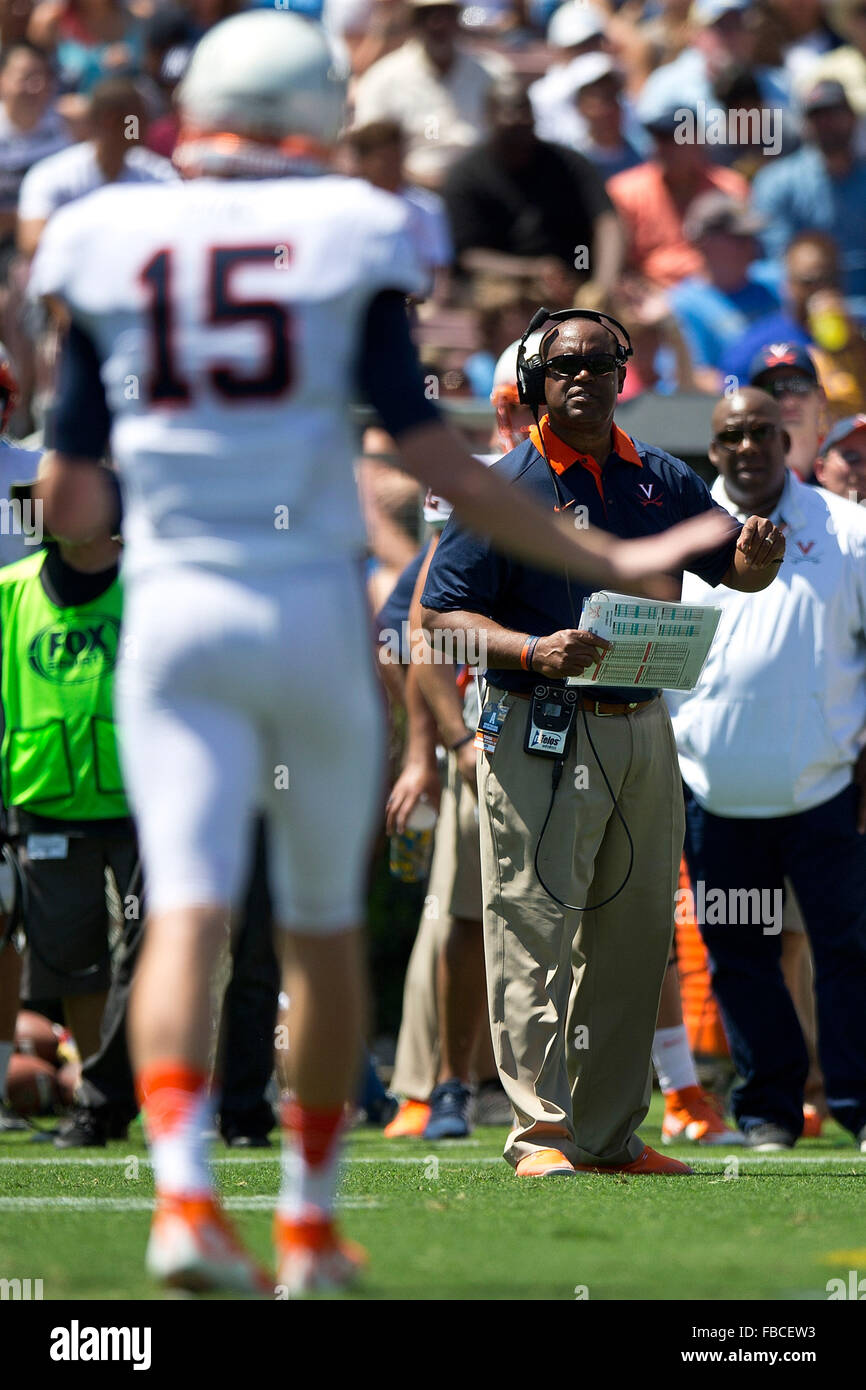 Head coach Mike London of the Virginia Cavaliers signals to quarterback ...