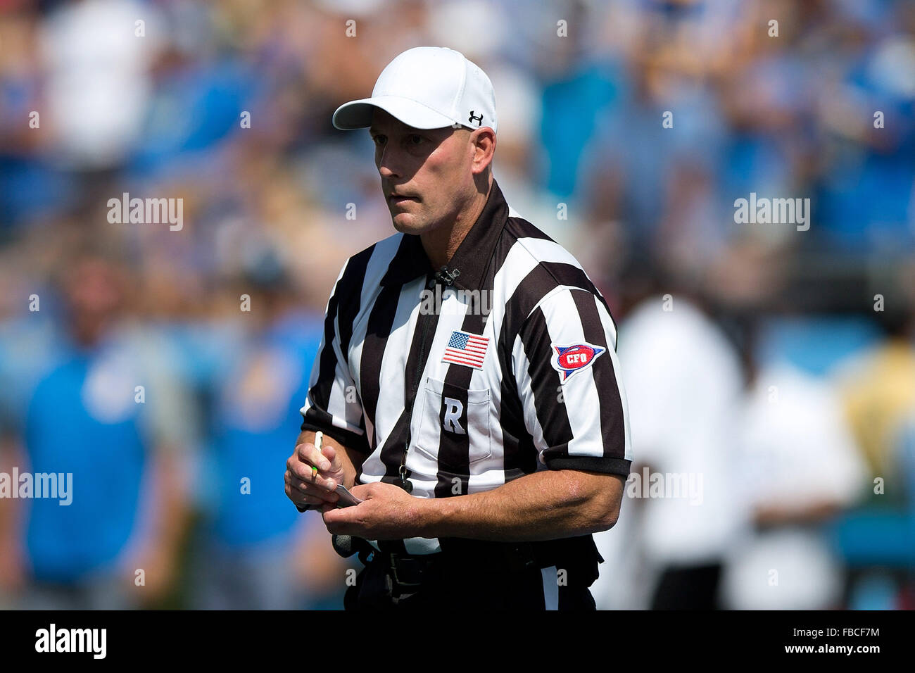 College football referee Jerry Magallanes stands on the field during ...