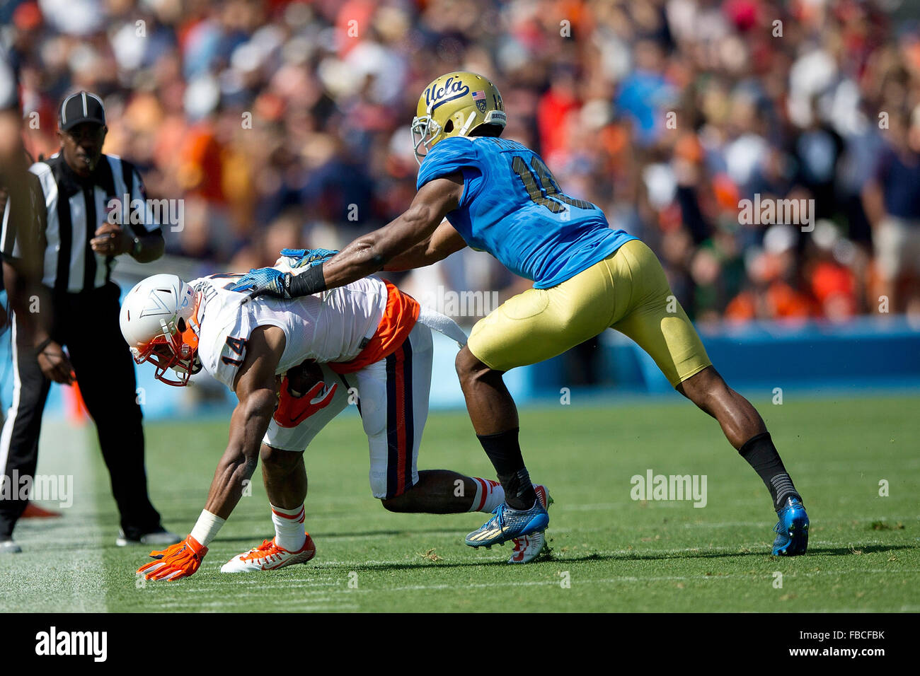 Wide receiver Andre Levrone #14 of the Virginia Cavaliers is pushed out ...