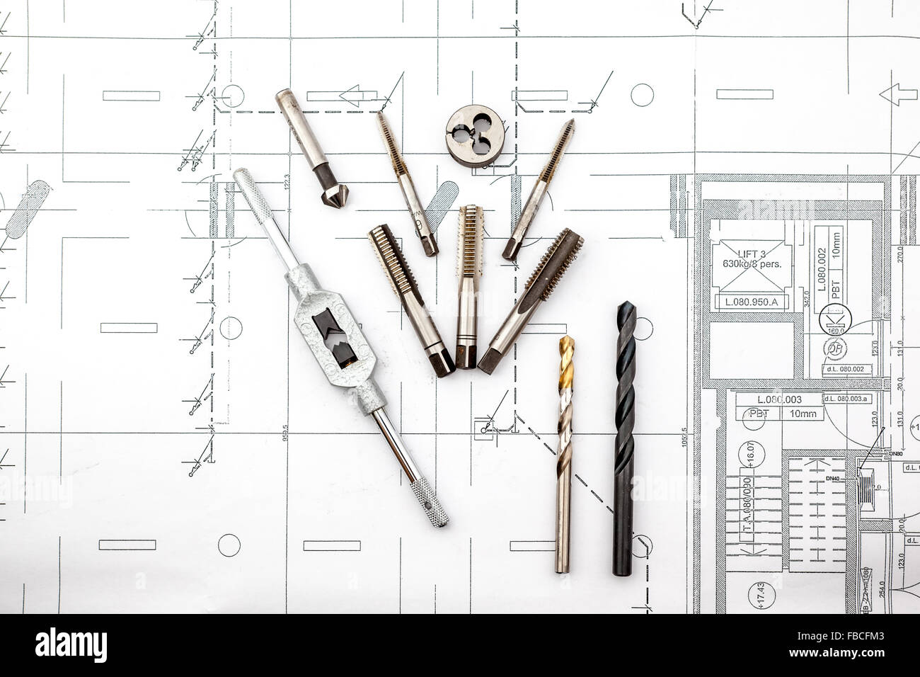 tapping operation plus spanner and drill on an house plan Stock Photo ...