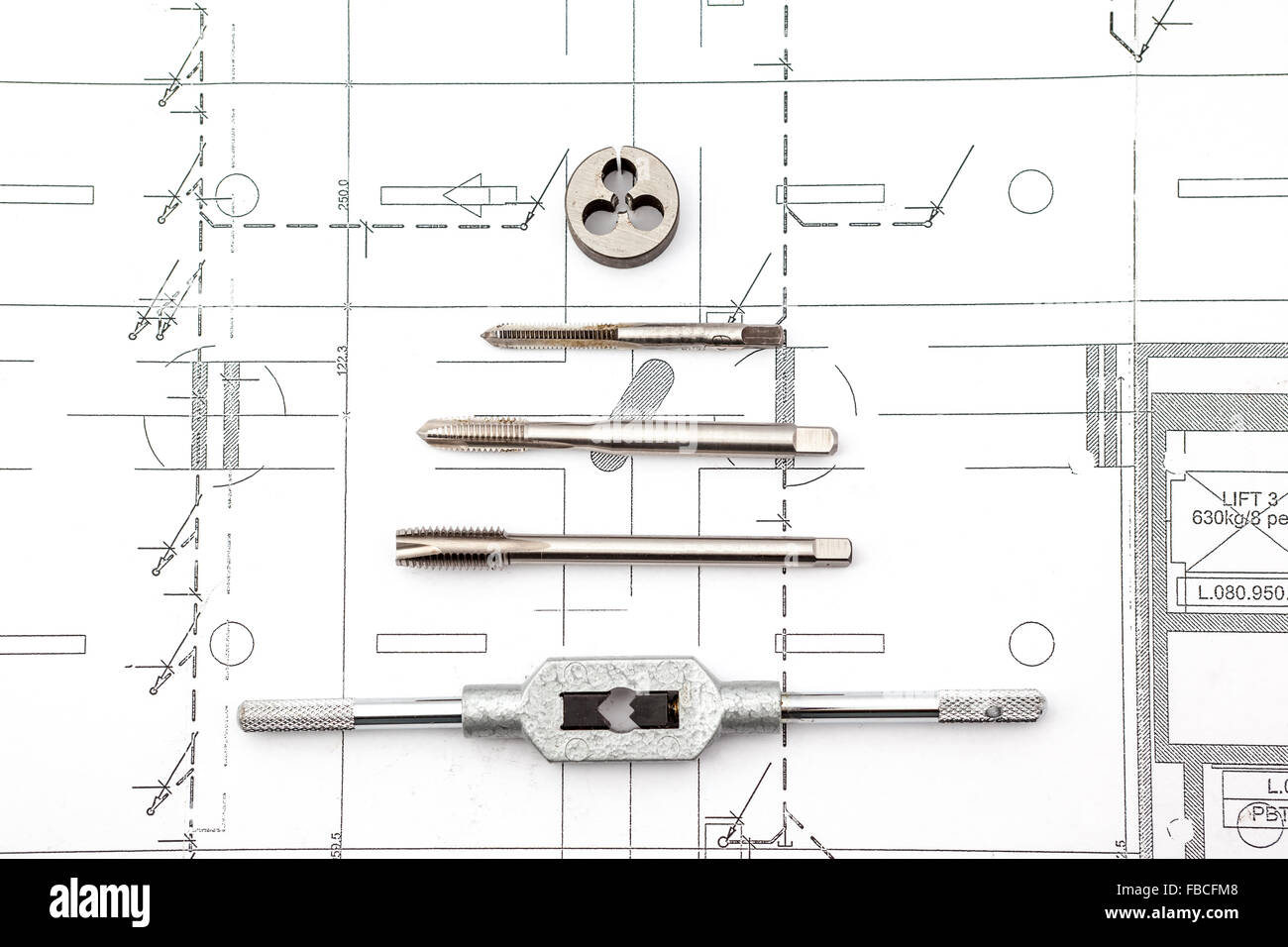 tapping operation plus spanner on an house plan Stock Photo - Alamy