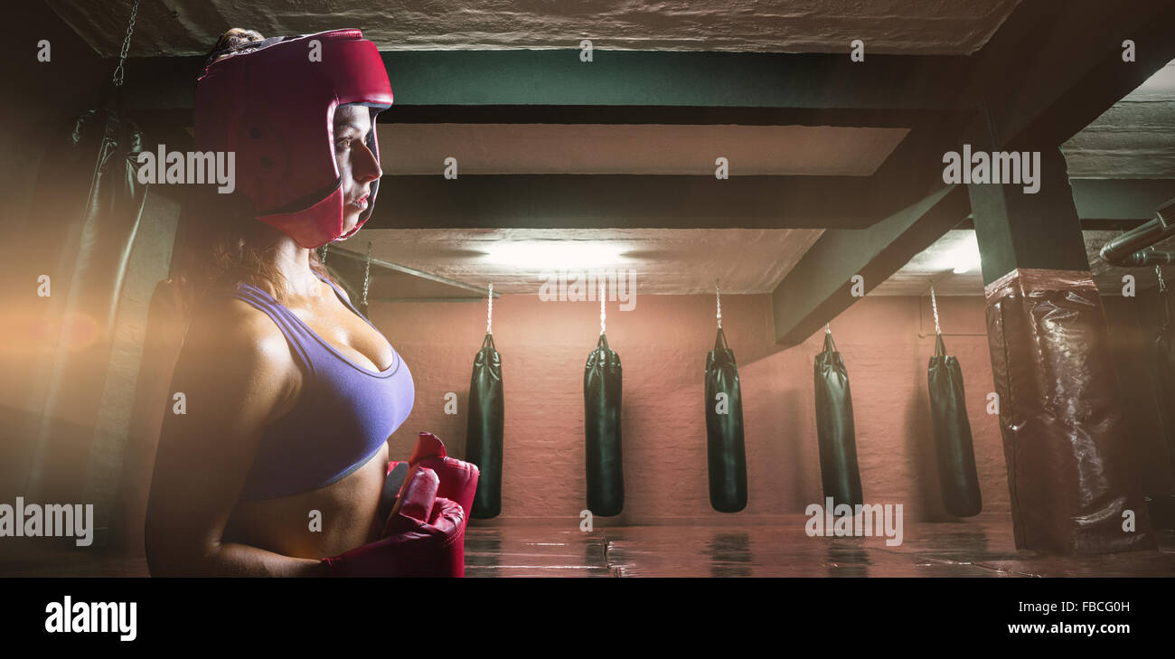 Composite image of side view of female boxer with headgear and gloves ...