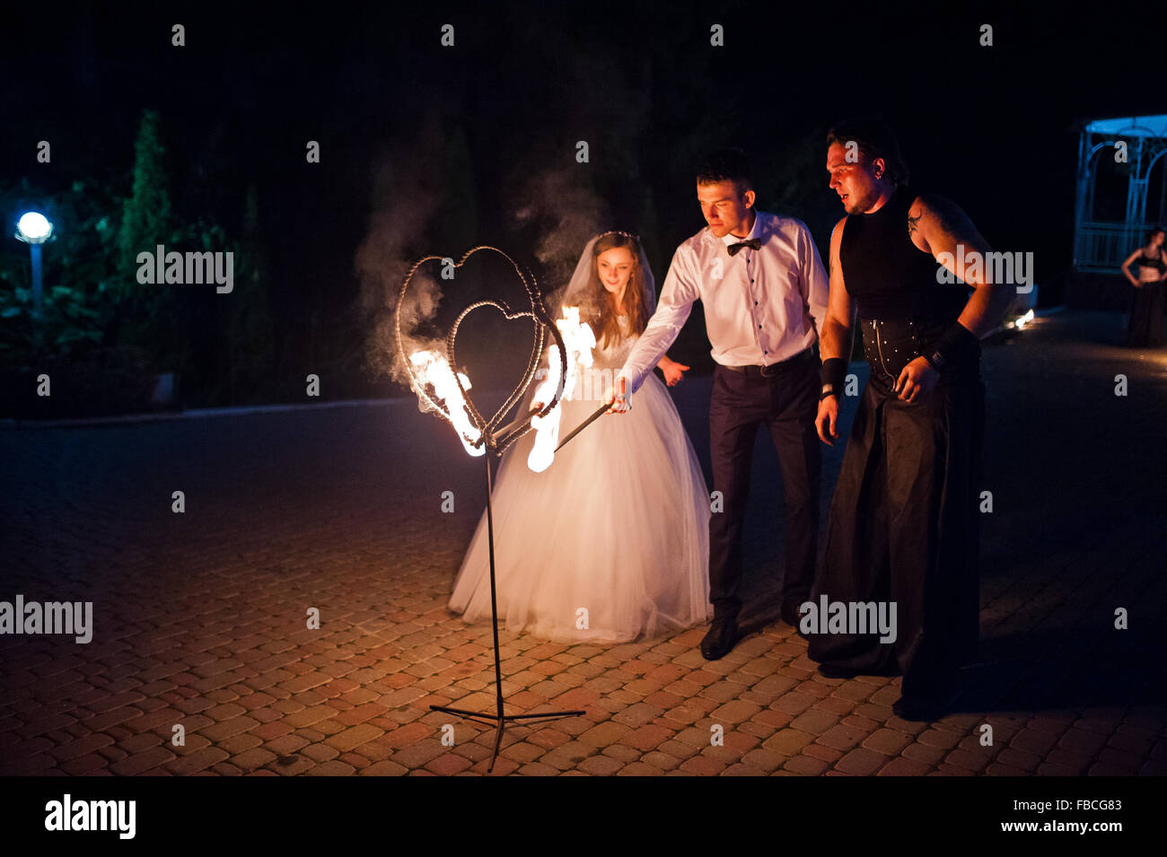 Amazing fire show on wedding ceremony at night Stock Photo - Alamy