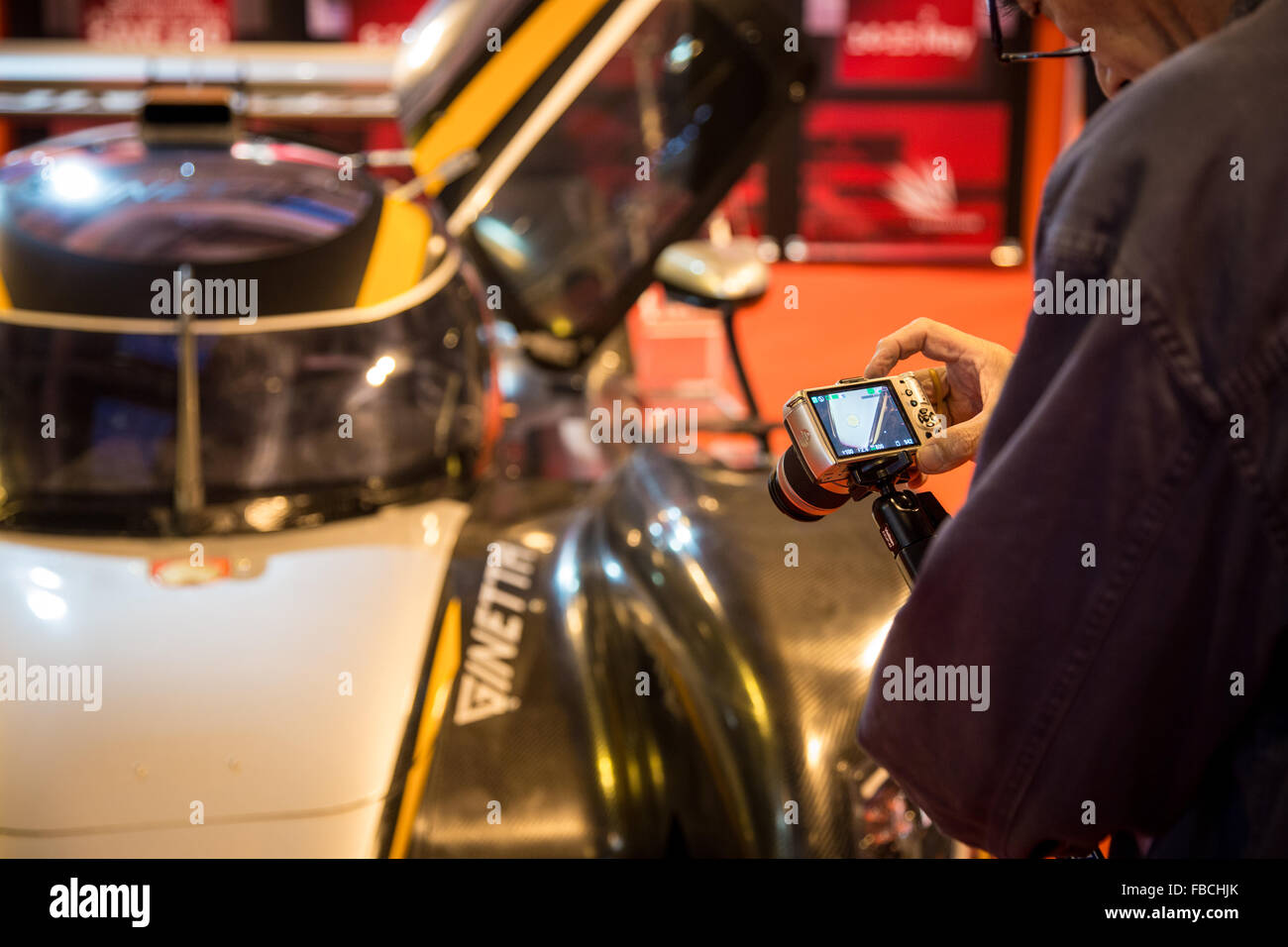 Visitor to the Autosport show taking photos of the cars Stock Photo - Alamy