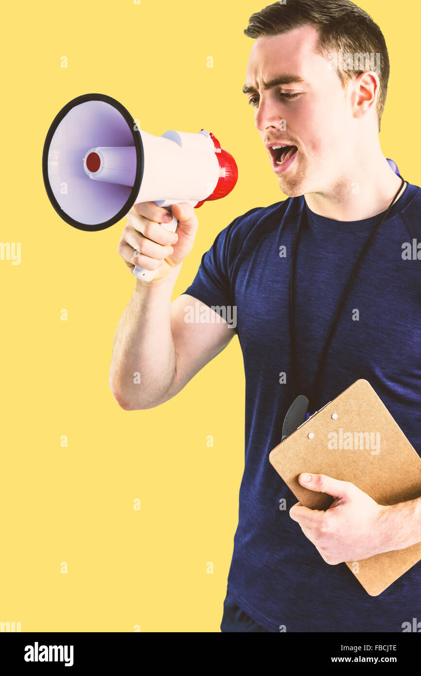 Composite image of male trainer yelling through the megaphone Stock ...