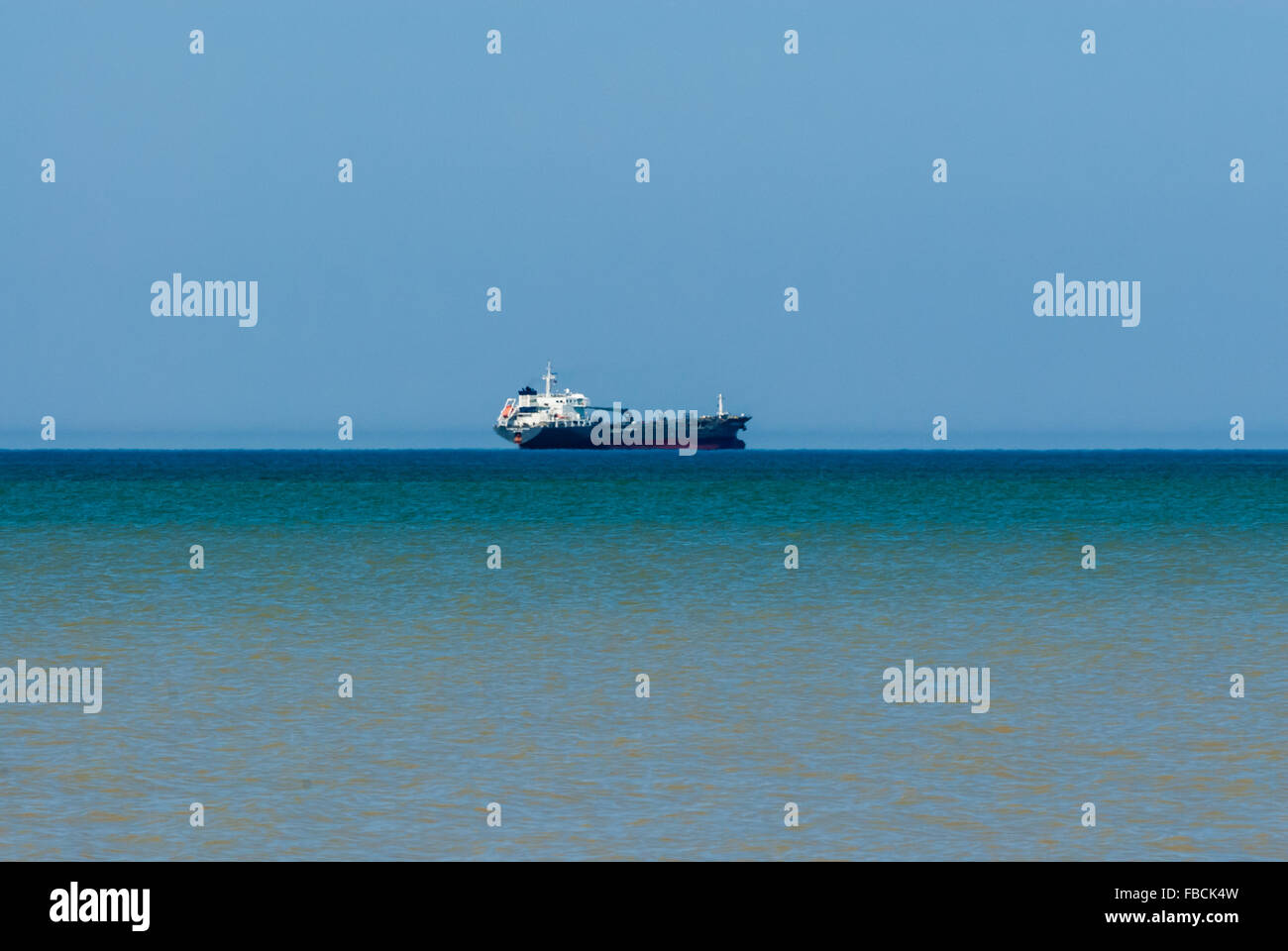 One cargo freighter ship in distance, on lake getting shallower as ...