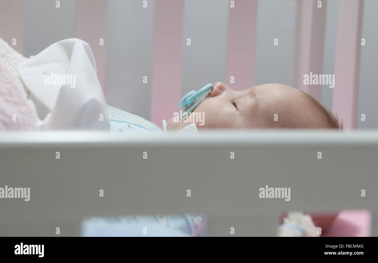 Baby in cot sleeping hi-res stock photography and images - Alamy
