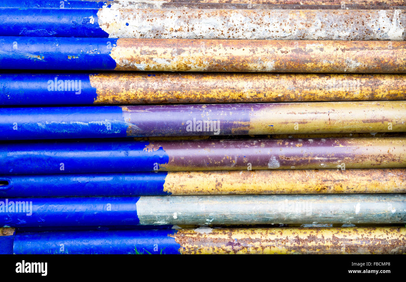 Old blue scaffolding bars with rust damage Stock Photo - Alamy