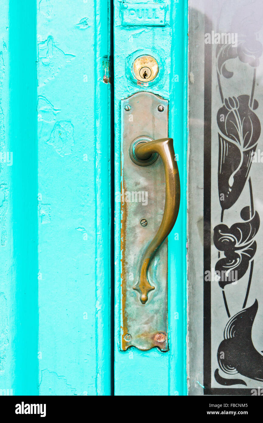 A vintage metal handle on a turquoise painted wooden door Stock Photo ...