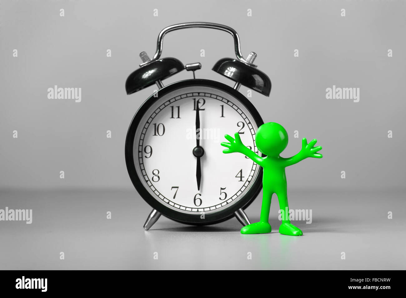 Green man and an alarm clock Stock Photo - Alamy