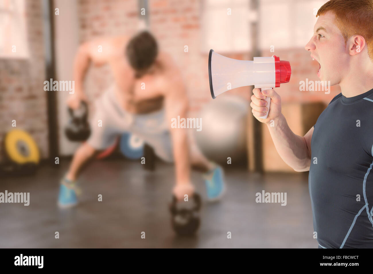 Composite image of angry rugby player yelling through the megaphone ...