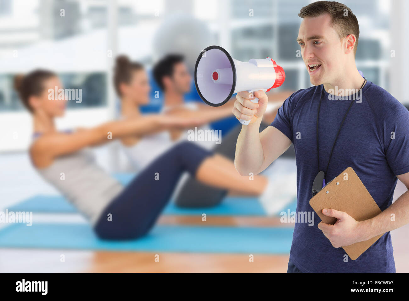 Composite image of male trainer yelling through the megaphone Stock ...