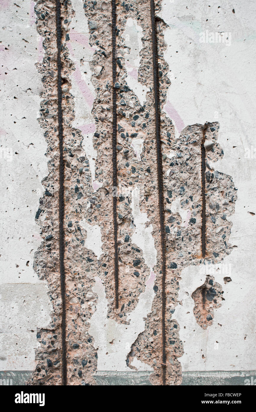 Part of a damaged old wall with exposed masonry and supporting metal ...